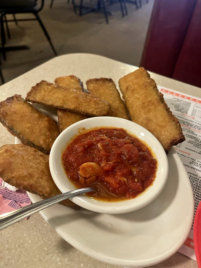 Golden-fried zucchini planks with marinara for dipping &ndash; the perfect starter while you wait for the main event to arrive.