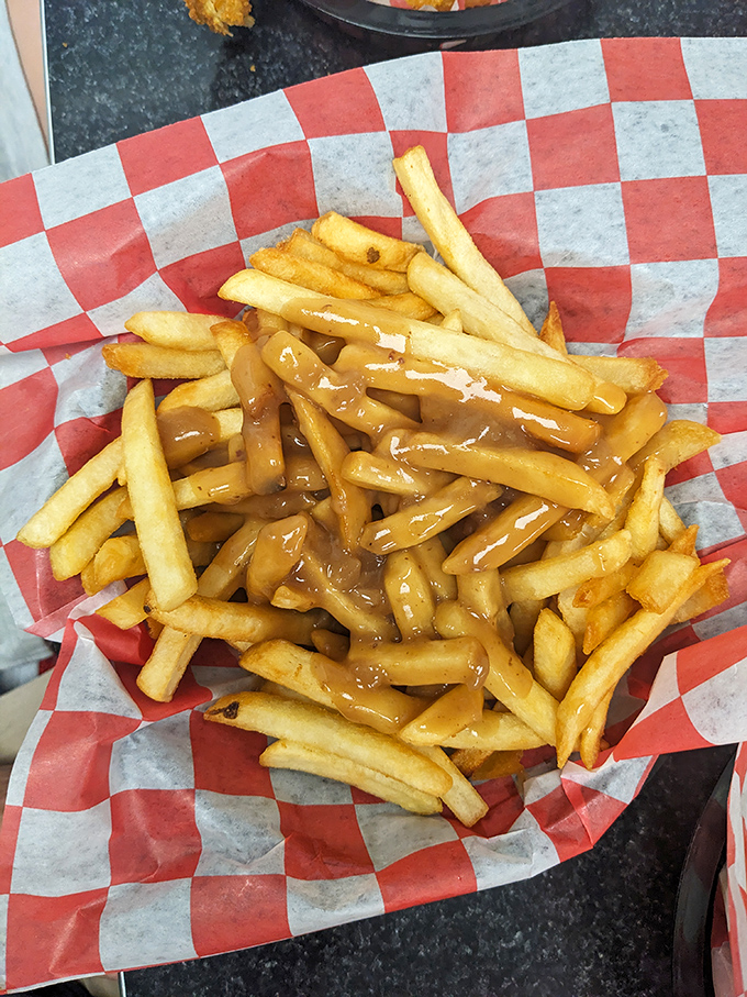 Gravy fries that make nutritionists weep and taste buds sing—golden potato sticks baptized in savory gravy that clings to each fry like it means it.