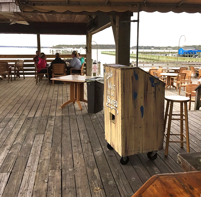 The weathered deck tells stories of countless summer meals, proving that sometimes the best dining room has no walls at all.