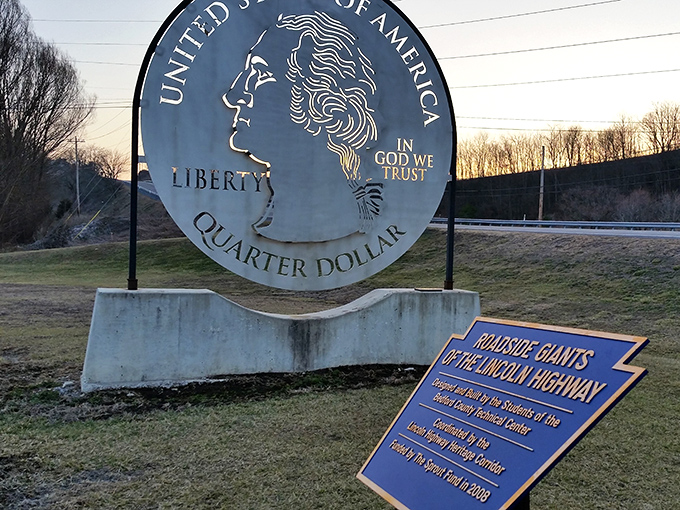 The informational plaque reveals the quarter's origin story&mdash;a testament to local students' creativity and the preservation of roadside culture.
