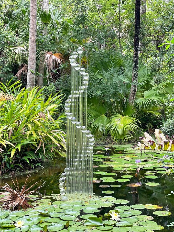 Glass spheres rise from lily pads like bubbles frozen in time. Dale Chihuly would give a standing ovation to this water-meets-art installation.