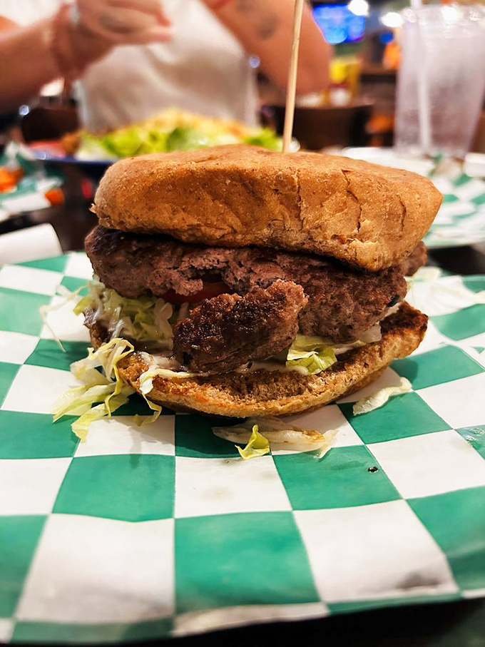 A burger stacked so high it needs architectural support, proving that in Texas, even sandwiches follow the "bigger is better" philosophy.
