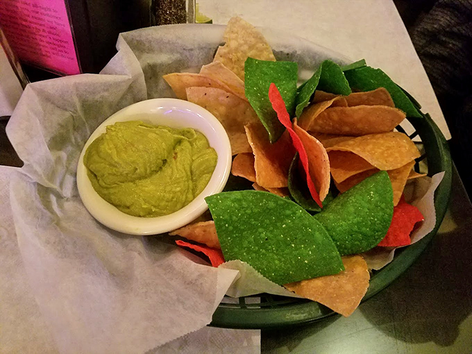 Vibrant guacamole with multicolored chips is like edible confetti for your taste buds. A celebration in every scoop.