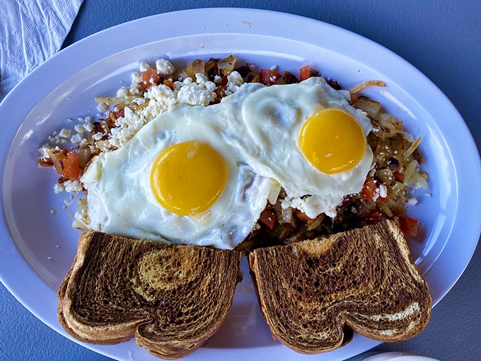 Two sunny eggs stand guard over a colorful skillet creation&mdash;a morning masterpiece that proves breakfast is the most important art of the day.