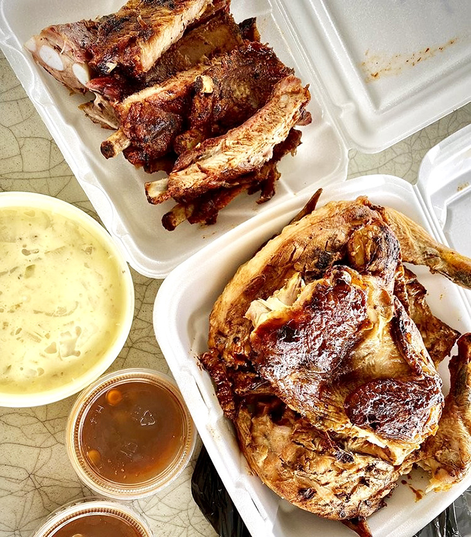The barbecue duet: smoky chicken and ribs sharing a tray with creamy sides. A harmony of flavors that sings the song of the South.