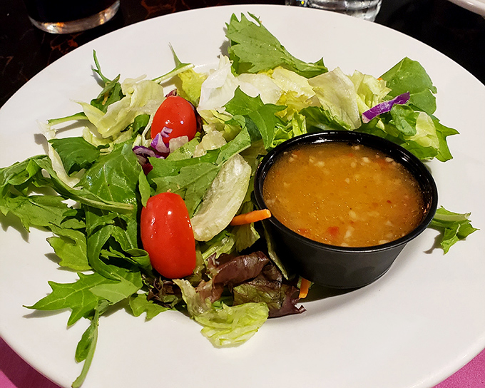 A house salad that doesn't just phone it in&mdash;fresh greens and vibrant tomatoes that remind you vegetables have a place at a steakhouse too.