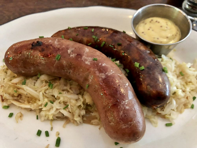 Housemade sausages resting on a bed of sauerkraut. These aren't just links&mdash;they're edible history lessons in Pennsylvania Dutch culinary tradition.
