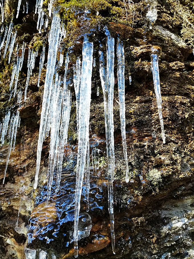 Winter's crystal chandeliers hang with perfect precision &ndash; nature's way of saying "you think the waterfall is impressive? Hold my beer."