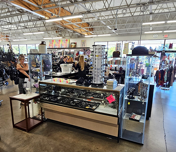 Jewelry counter where treasures sparkle under fluorescent lights. One person's discarded accessories become another's statement pieces at fraction-of-retail prices.