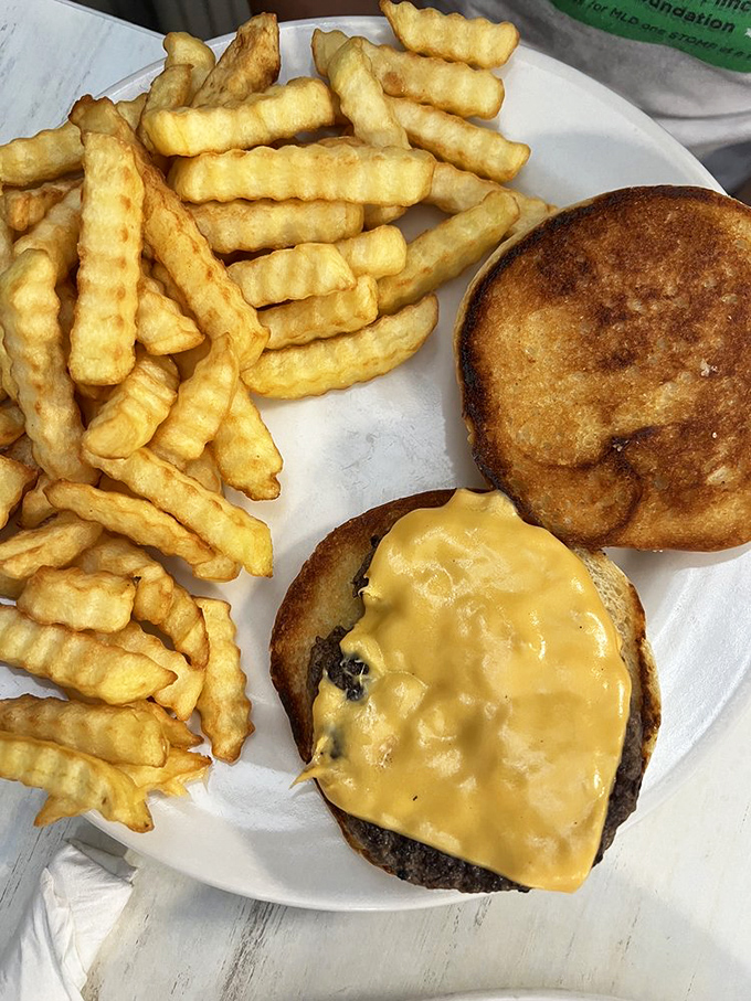 The humble cheeseburger and crinkle-cut fries&mdash;proof that simplicity, when done right, needs no improvement. American comfort food at its finest.
