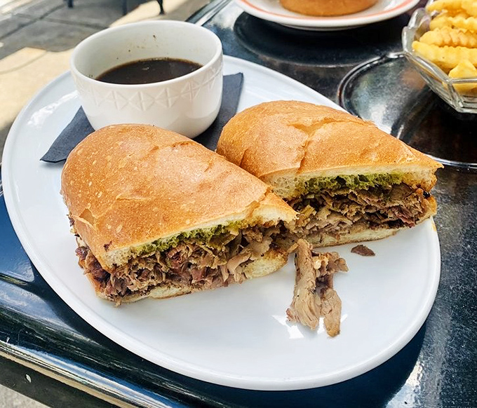 The French dip sandwich—where thinly sliced meat meets crusty bread in a romance that only gets better with a dip in that dark, savory au jus.