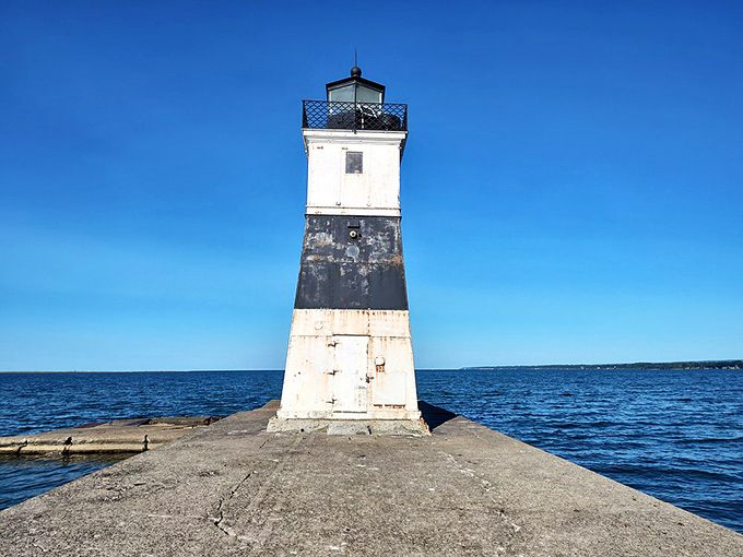 This striking beacon stands guard where water meets sky, creating postcard-perfect moments for lighthouse enthusiasts.