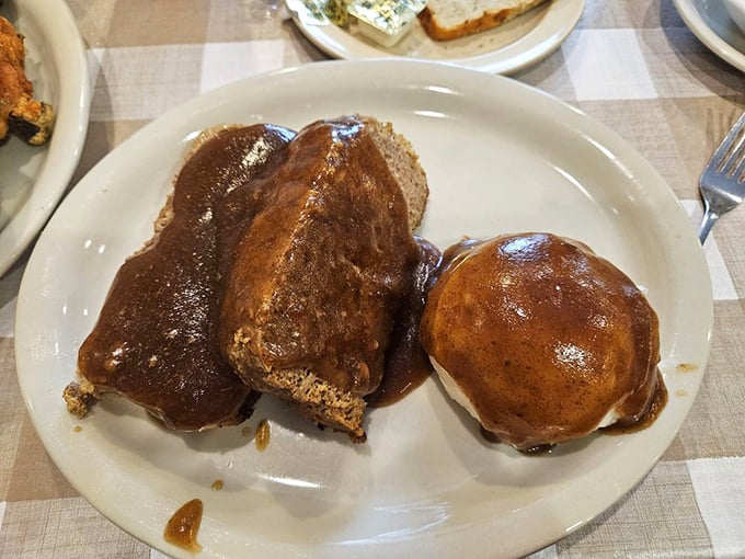 Meatloaf bathed in rich brown gravy—the kind that makes you want to hug the chef and ask if they'd consider adoption.