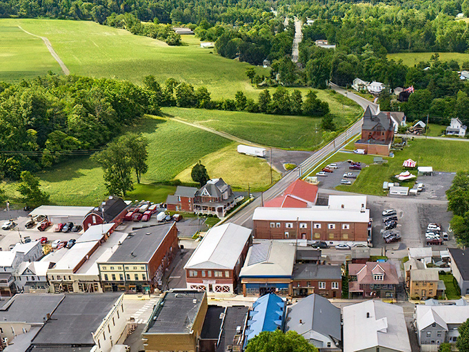 Aerial view reveals Millheim nestled in green valleys like a precious gem hidden in nature's jewelry box.