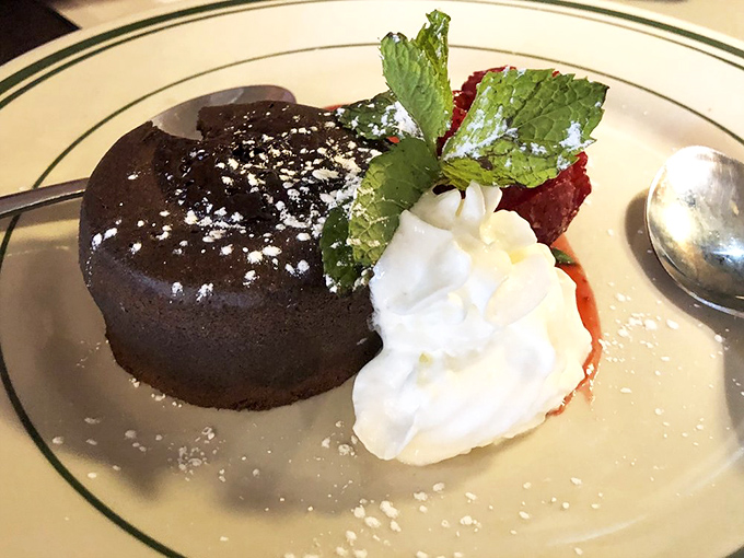 A chocolate lava cake that doesn't just ooze&mdash;it performs. That mint sprig and whipped cream aren't garnishes; they're supporting actors in this dessert drama.