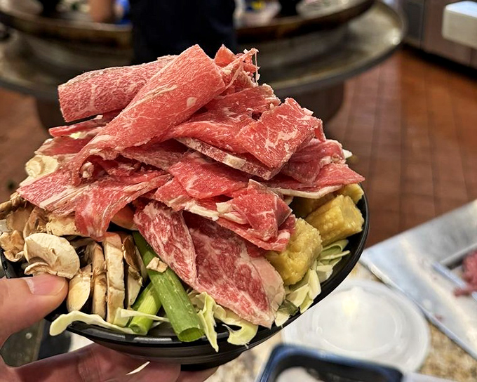 A mountain of fresh ingredients awaiting transformation at the Mongolian grill station&mdash;proof that sometimes the best meals are the ones you help create yourself.