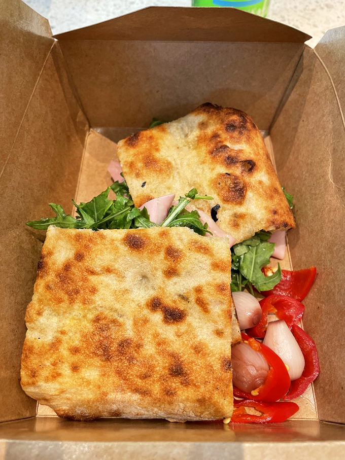 A focaccia sandwich bursting with mortadella, arugula, and roasted peppers. Proof that even the supporting actors in this pizza drama deserve standing ovations.