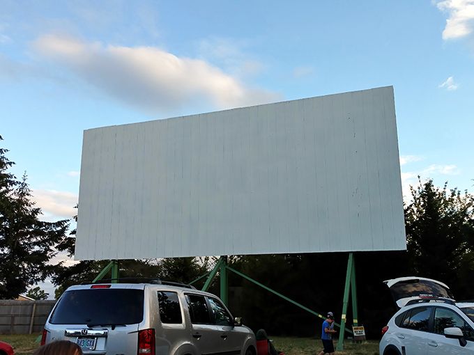 The massive white screen stands ready for its nightly transformation&mdash;from blank canvas to window into other worlds as cars gather below.