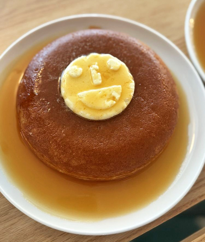 That pancake isn't just smiling at you&mdash;it's practically winking, floating in a maple syrup pool that's basically breakfast nirvana on a plate. 