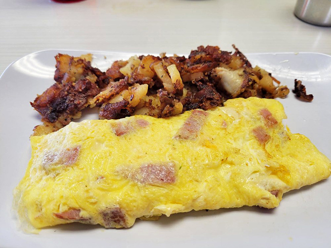 An omelet and home fries combo that defines breakfast perfection. Those crispy potatoes didn't just happen—they were loved into existence.