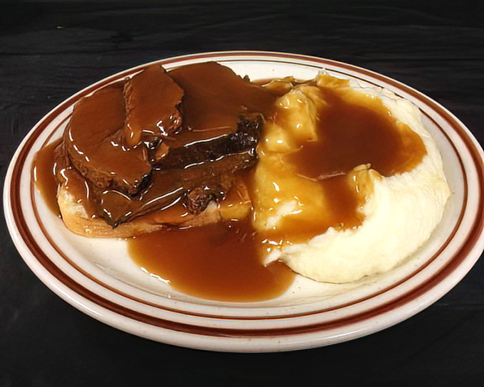 The open-faced roast beef sandwich&mdash;comfort food royalty wearing a crown of gravy. Mashed potatoes stand by, ready to soak up every delicious drop.
