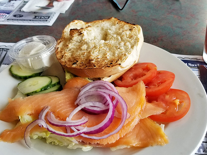 The open-faced salmon sandwich: proof that sometimes less is more. Vibrant vegetables and buttery fish create a symphony of flavors on toasted bread.