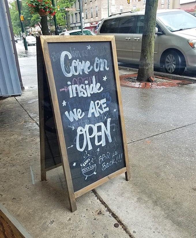 A simple sidewalk sign that delivers the most important message - come in, we're ready to serve.