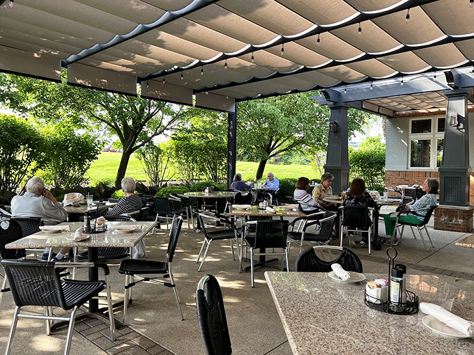 The outdoor patio extends the dining experience into nature, where fresh air enhances every bite and conversation flows freely.