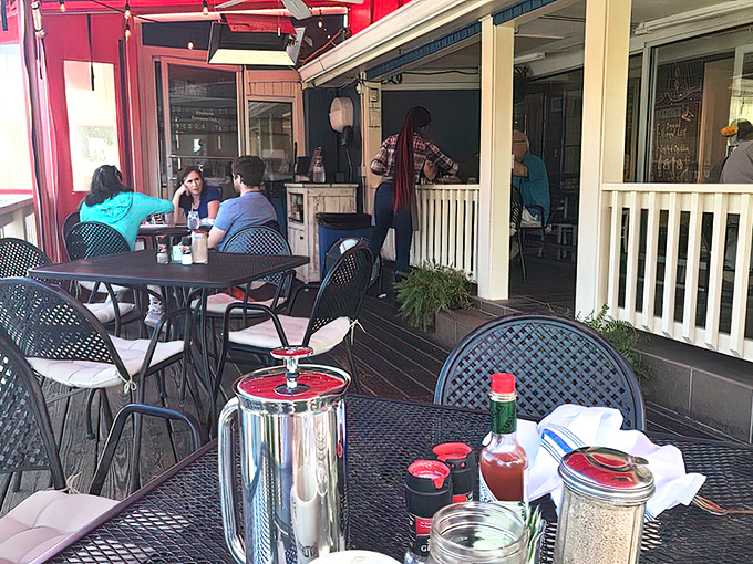Outdoor seating where Atlanta's weather becomes part of the experience, with red awnings providing shade for serious breakfast contemplation.