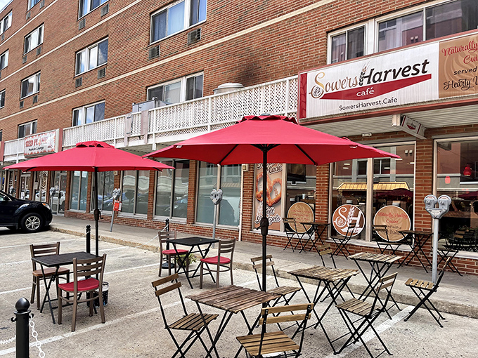 Outdoor seating that transforms a simple sidewalk into an urban oasis. Those red umbrellas are practically winking at passersby.