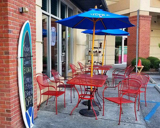Sunshine optional, flavor mandatory! The cheerful outdoor seating area with surfboard menu board invites you to enjoy South Carolina's pleasant weather.
