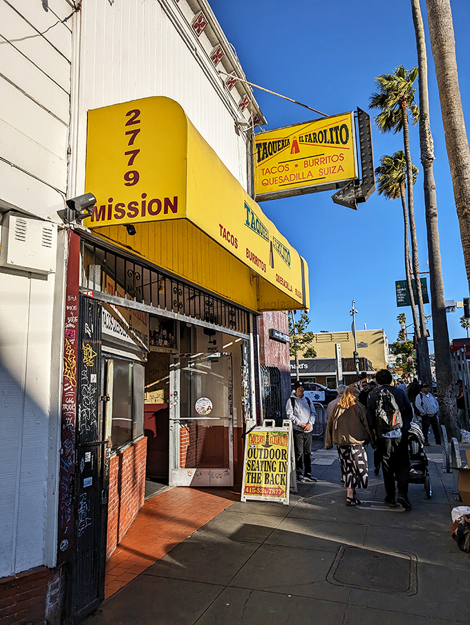 The sidewalk scene&mdash;where the anticipation of what's inside that yellow awning makes even the wait feel like part of the experience.