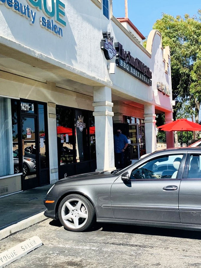 Even the palm trees seem to lean in, drawn by the irresistible aroma of slow-smoked perfection.