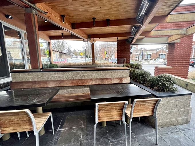 The outdoor patio whispers promises of al fresco dining when Ohio weather cooperates. Those wooden benches have witnessed countless first dates and morning-after debriefs.