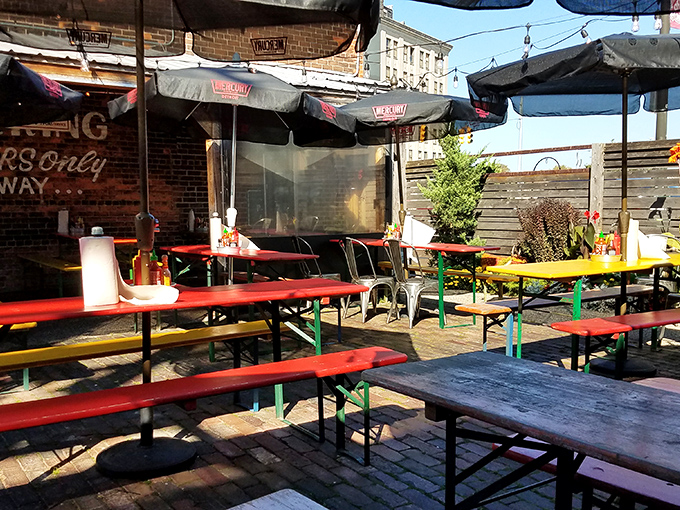 Mercury's outdoor seating area offers colorful picnic tables, fresh air, and the perfect spot to devour a burger while people-watching in Corktown.