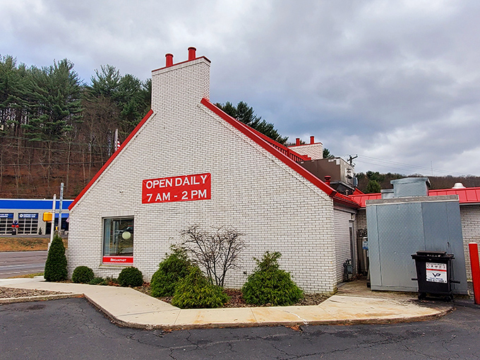 White brick, red roof, and operating hours that acknowledge the truth: all great breakfast adventures should begin at 7 AM sharp.