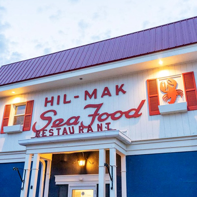 Evening lights illuminate this seafood sanctuary, beckoning hungry travelers like a lighthouse guides ships safely to shore.