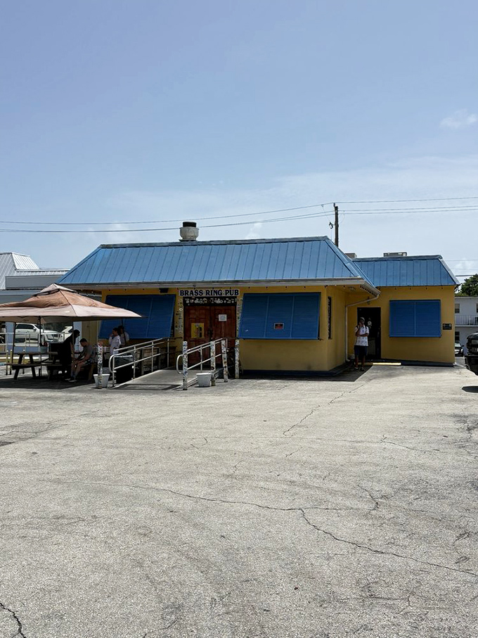 In the harsh light of day, the yellow building with blue shutters doesn't look like much. But locals know—true flavor often hides in plain sight.