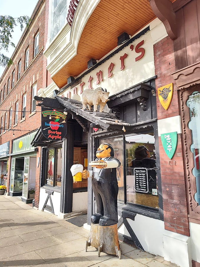 The welcoming exterior promises authentic experiences inside. That wooden cheese ambassador has seen generations of happy diners come and go.