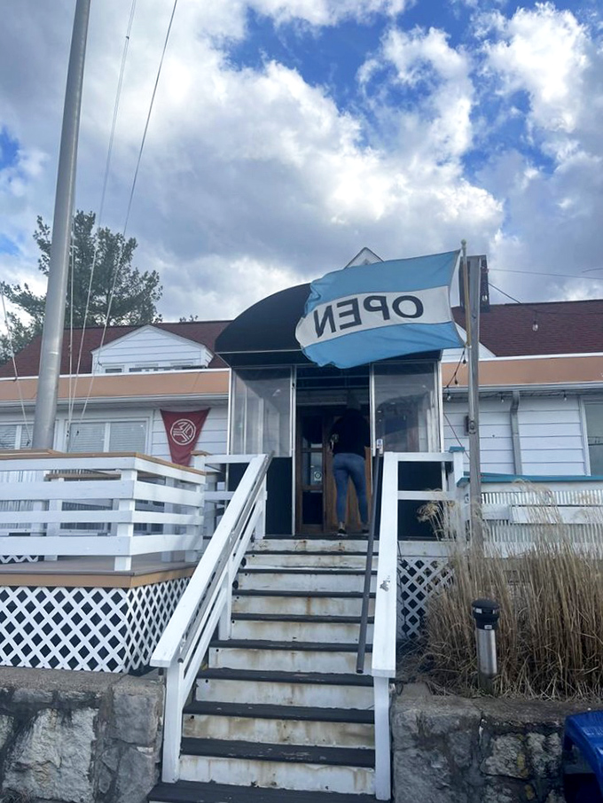 The entrance says "casual" but the flag says "open"&mdash;a combination that perfectly captures the inviting spirit of this lakeside gem.