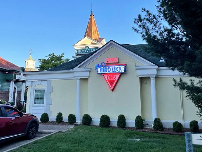 Mel's Hard Luck Diner glows with evening promise, a beacon of nostalgia nestled in Branson's Grand Village Shops.