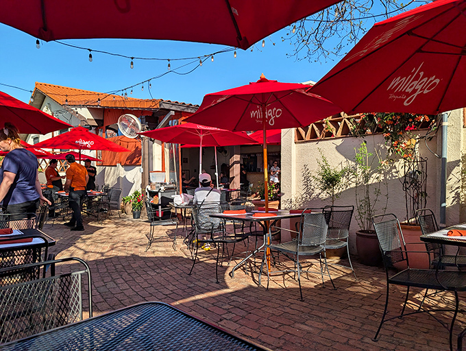 The outdoor dining area offers a slice of Austin heaven &ndash; string lights, red umbrellas, and the promise of enchiladas under the Texas sky.