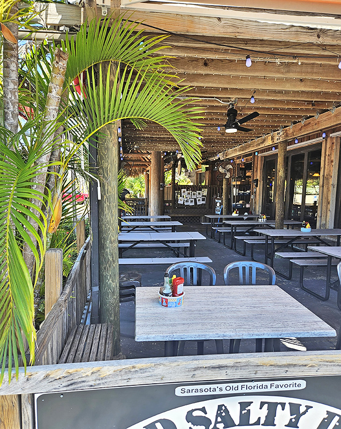 The outdoor dining area, where weathered wood and palm fronds create the perfect backdrop for seafood feasts with a side of Florida sunshine.