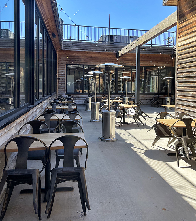 The outdoor dining area offers fresh air and ambiance. String lights stand ready to transform evening meals into magical al fresco experiences.