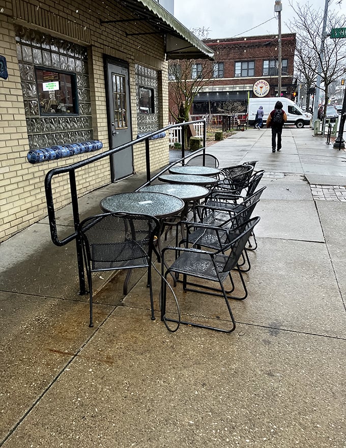 Even on rainy days, the outdoor seating stands ready &ndash; because sometimes coffee tastes better with a side of fresh air and people-watching opportunities.