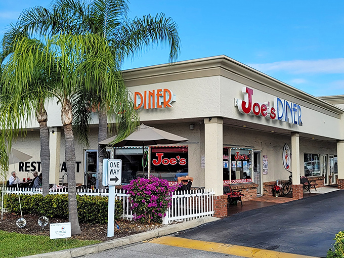 Palm trees stand guard outside this temple of breakfast, where purple bougainvillea adds tropical flair to diner tradition.