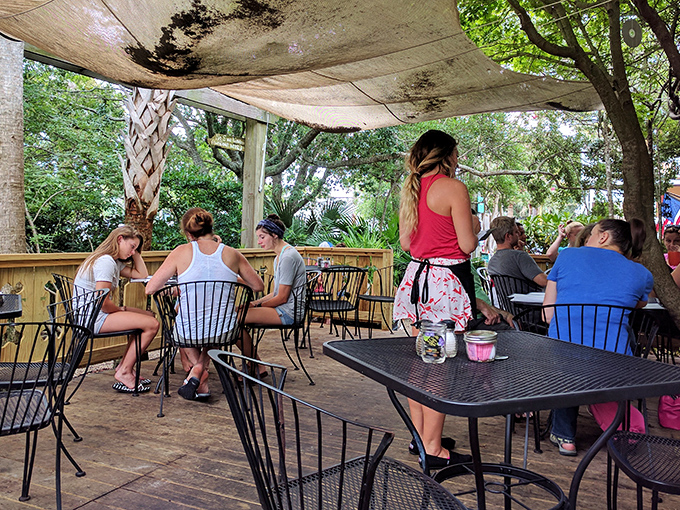 The outdoor patio where dappled sunlight filters through palm fronds. Perfect for people-watching while your breakfast digests.