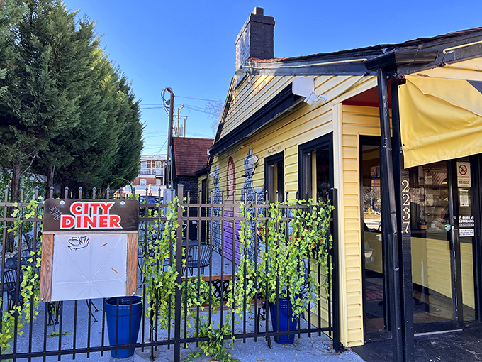 The cheerful exterior with its wrought iron fence and vibrant signage welcomes hungry visitors like an old friend who knows exactly what you need.