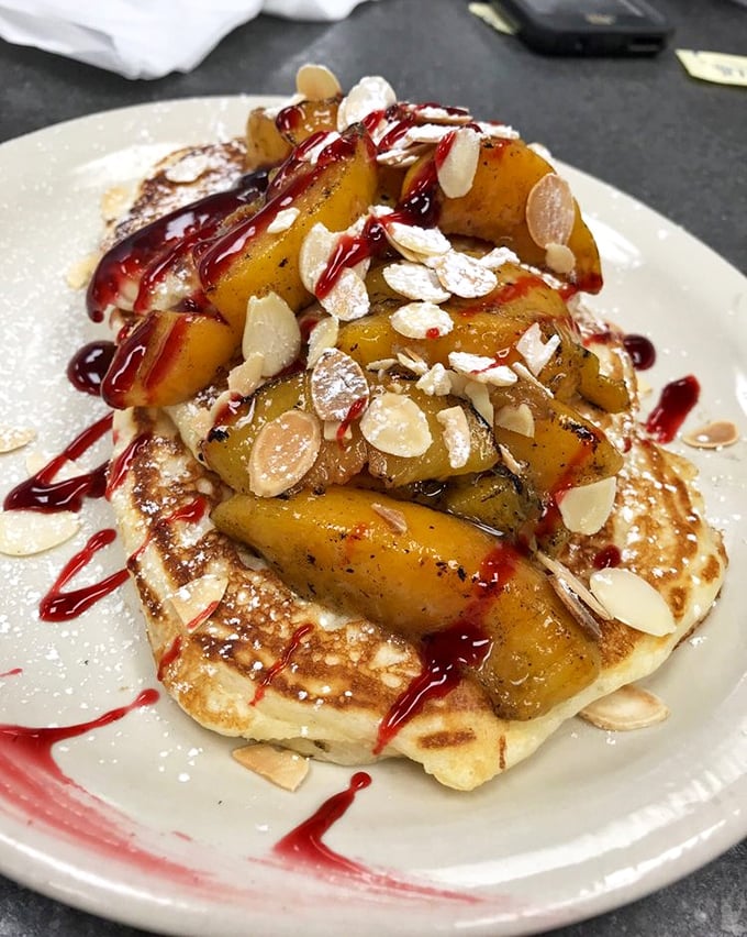 Caramelized bananas and raspberry drizzle transform ordinary pancakes into something that belongs in both breakfast and dessert categories.