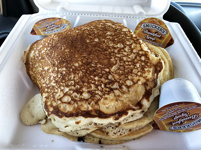 Pancakes so perfectly golden they belong in Fort Knox. Served in a to-go container because sometimes life's greatest pleasures need to be enjoyed on the road. 